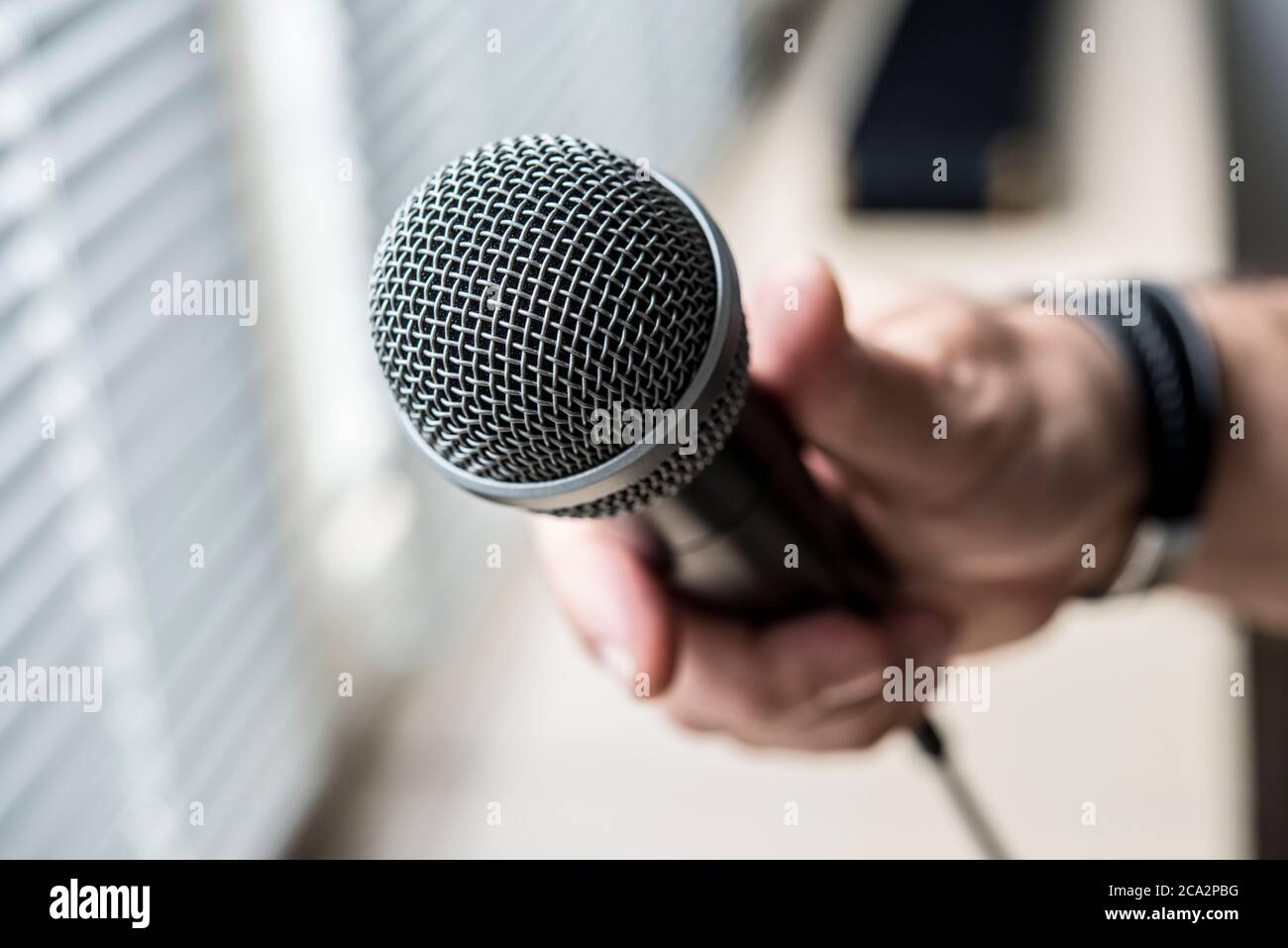 Man holding microphone hi-res stock photography and images - Alamy