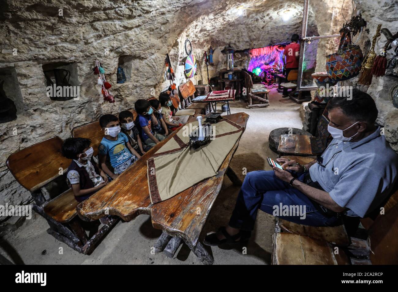 A Syrian family Abd al-Mu’ti Abu Muhammad, displaced turns a cave ...