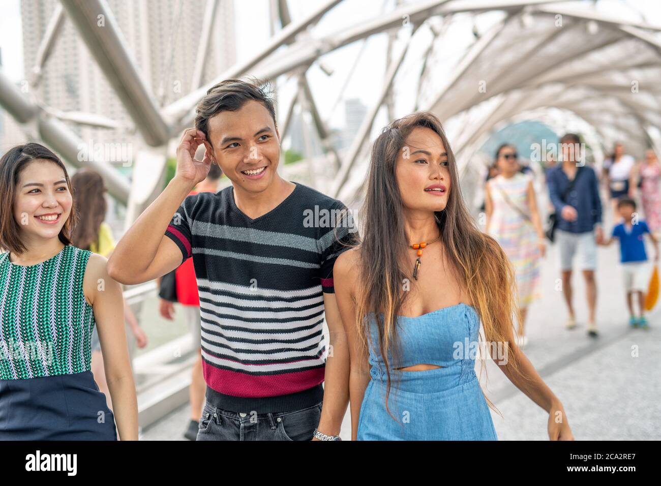 Three asian young friends spending free time outdoor together Stock ...