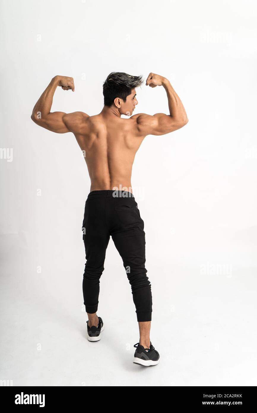 full body image of young man showing muscular body stand facing back on ...