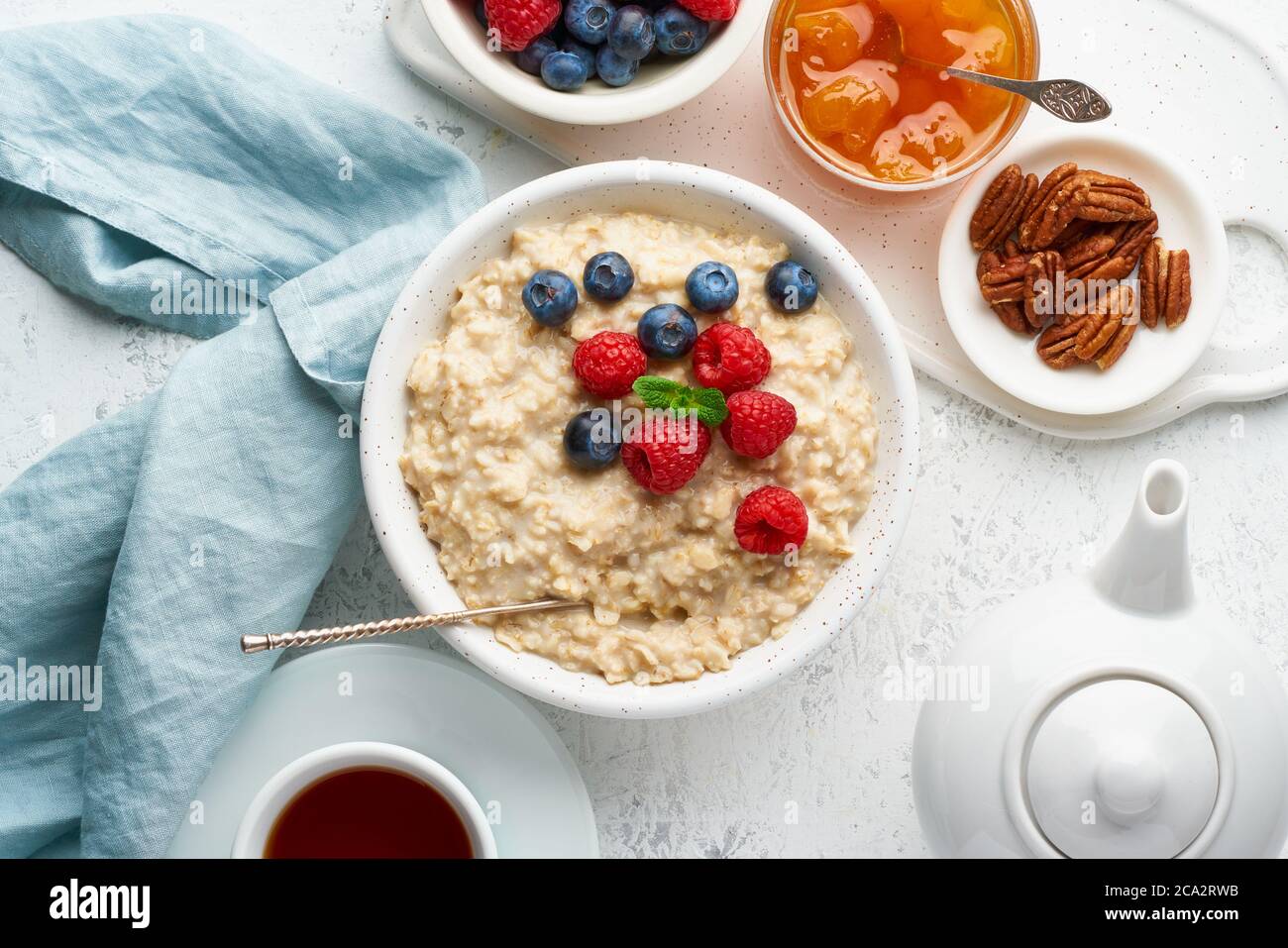 Oatmeal porridge with blueberry, raspberries, jam and nuts, top view ...
