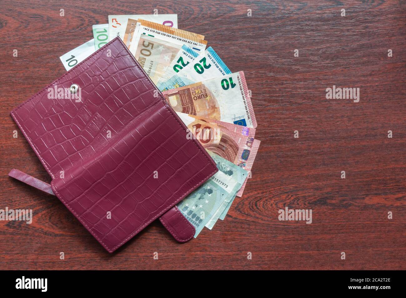 Euro banknotes and leather wallet on wood background. Leather wallet ...