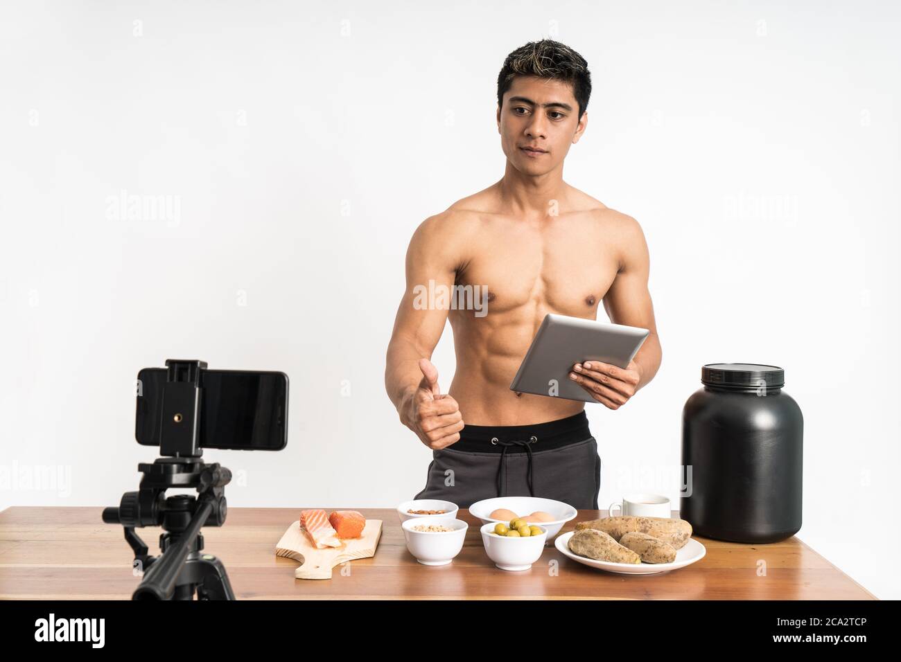 muscular man health and sports blogger with thumbs up showing healthy ...