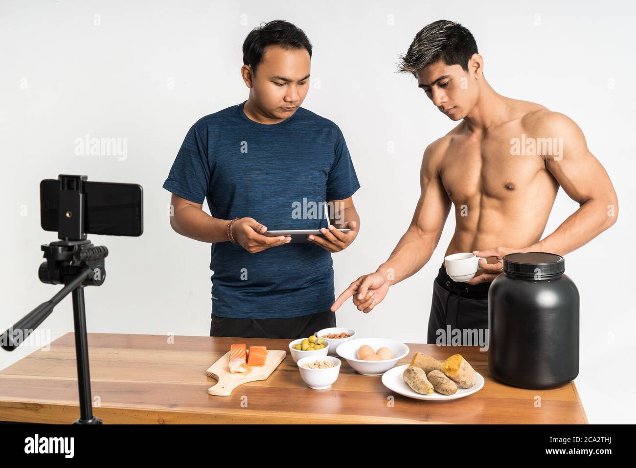 two health and sports blogger with finger pointing healthy food menu ...