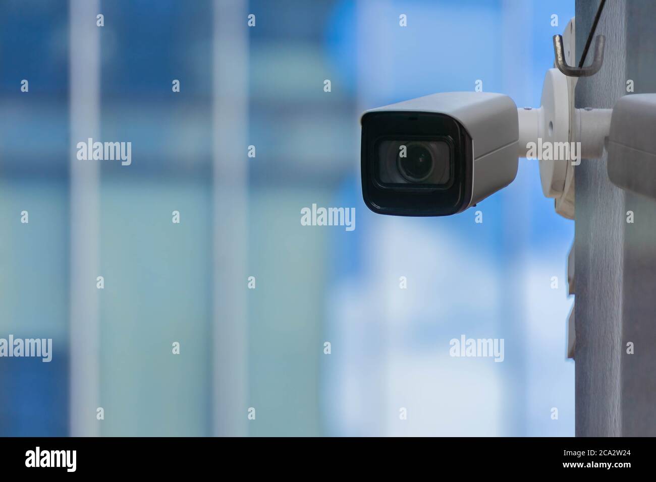 Modern CCTV security camera installed on building wall in city. Concept ...