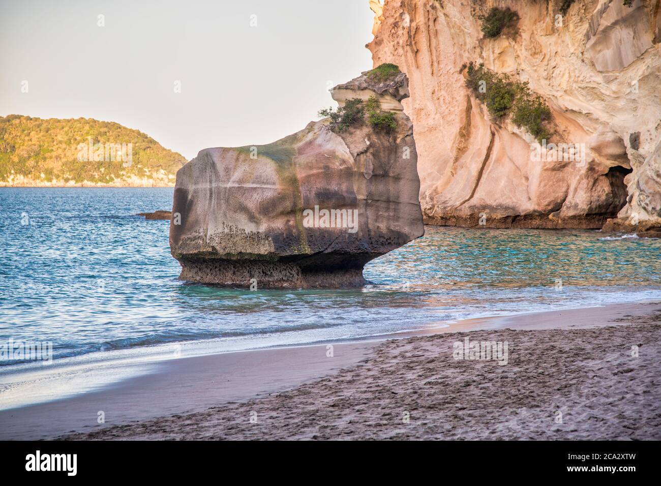 Sunset view of Cathedral Cove, rock formation above the sea, New ...