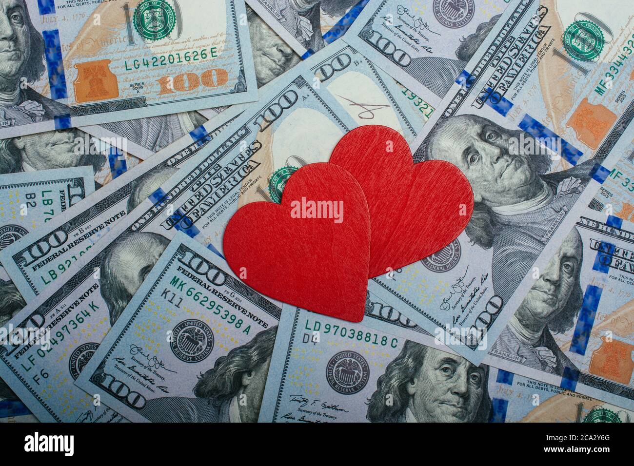 Red hearts on dollar bills. Concept of selling love for money Stock ...