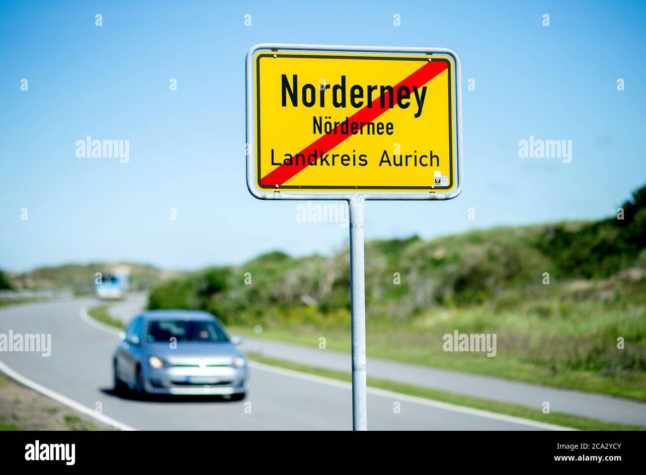 Norderney, Germany. 12th July, 2020. A car drives past a place-name ...
