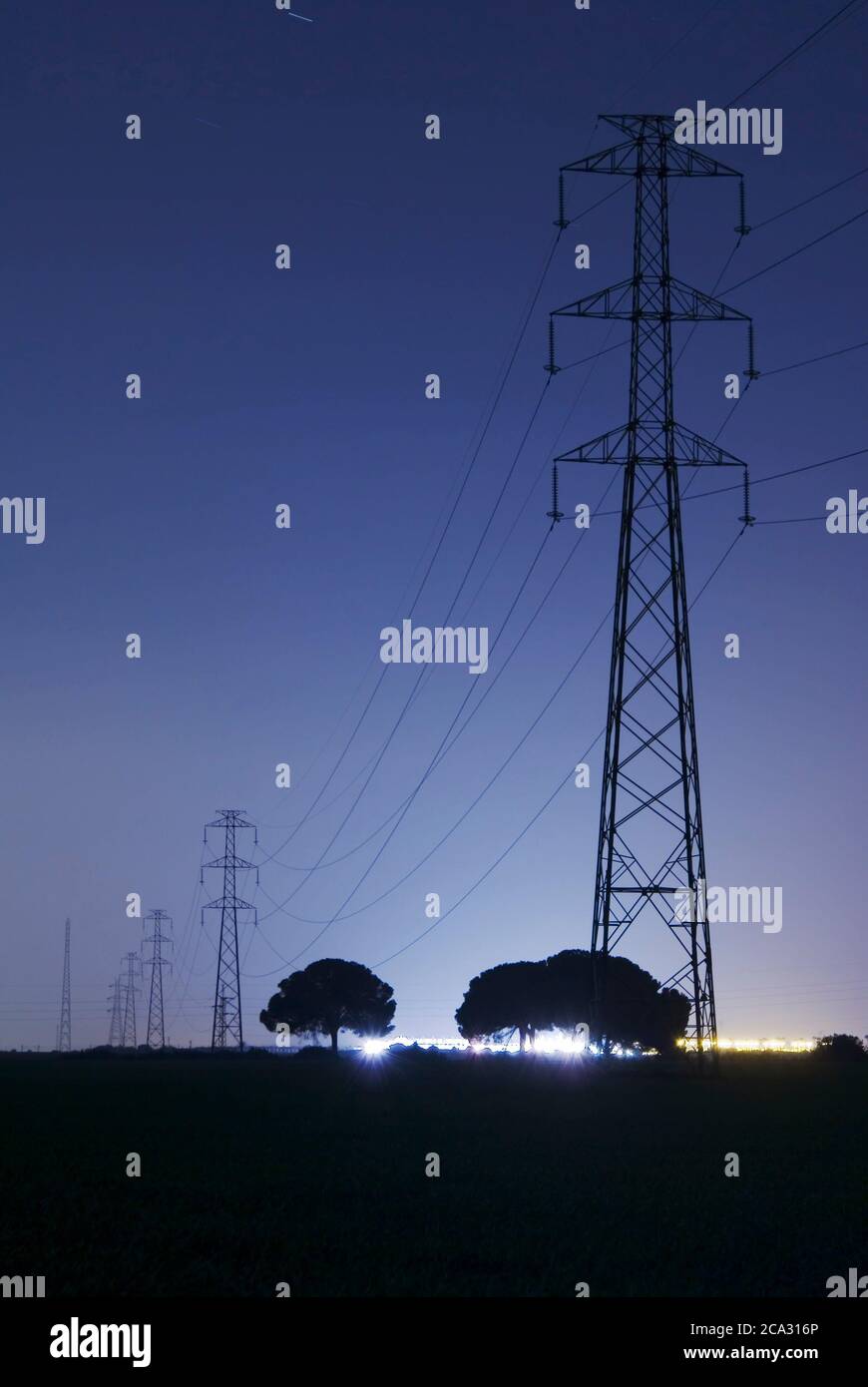 high voltage power line at night in Seville. Spain Stock Photo - Alamy