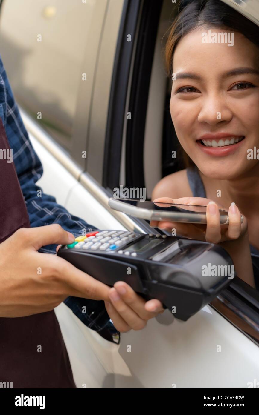 Asian woman customer make mobile payment contactless technology to ...