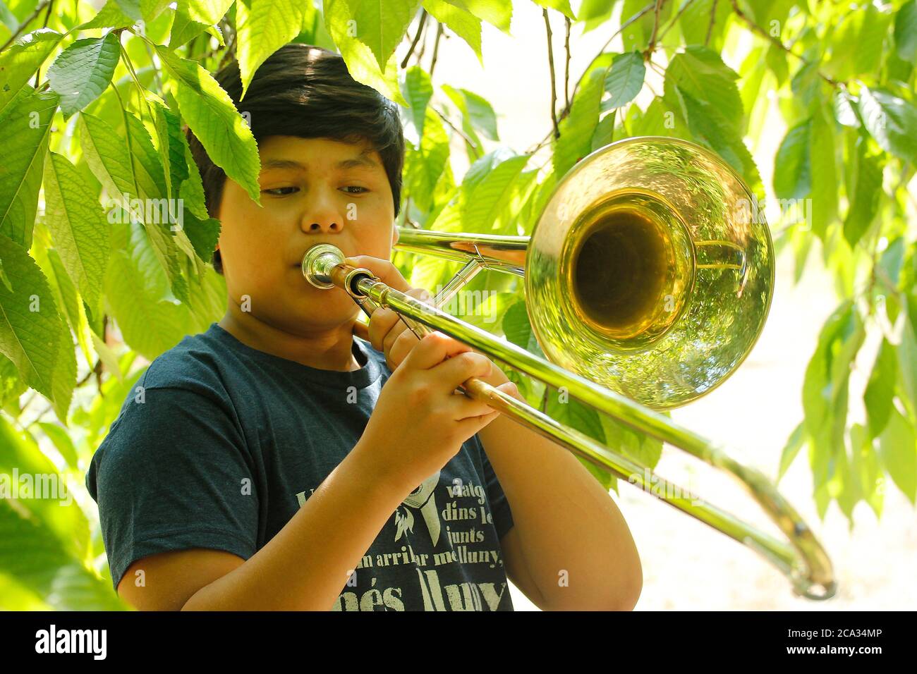Boy playing the trombone hi-res stock photography and images - Alamy