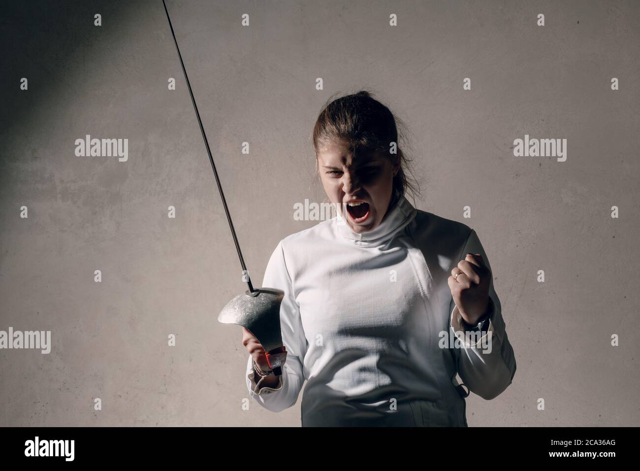 Fencer woman victory win emotions with fencing sword Stock Photo - Alamy