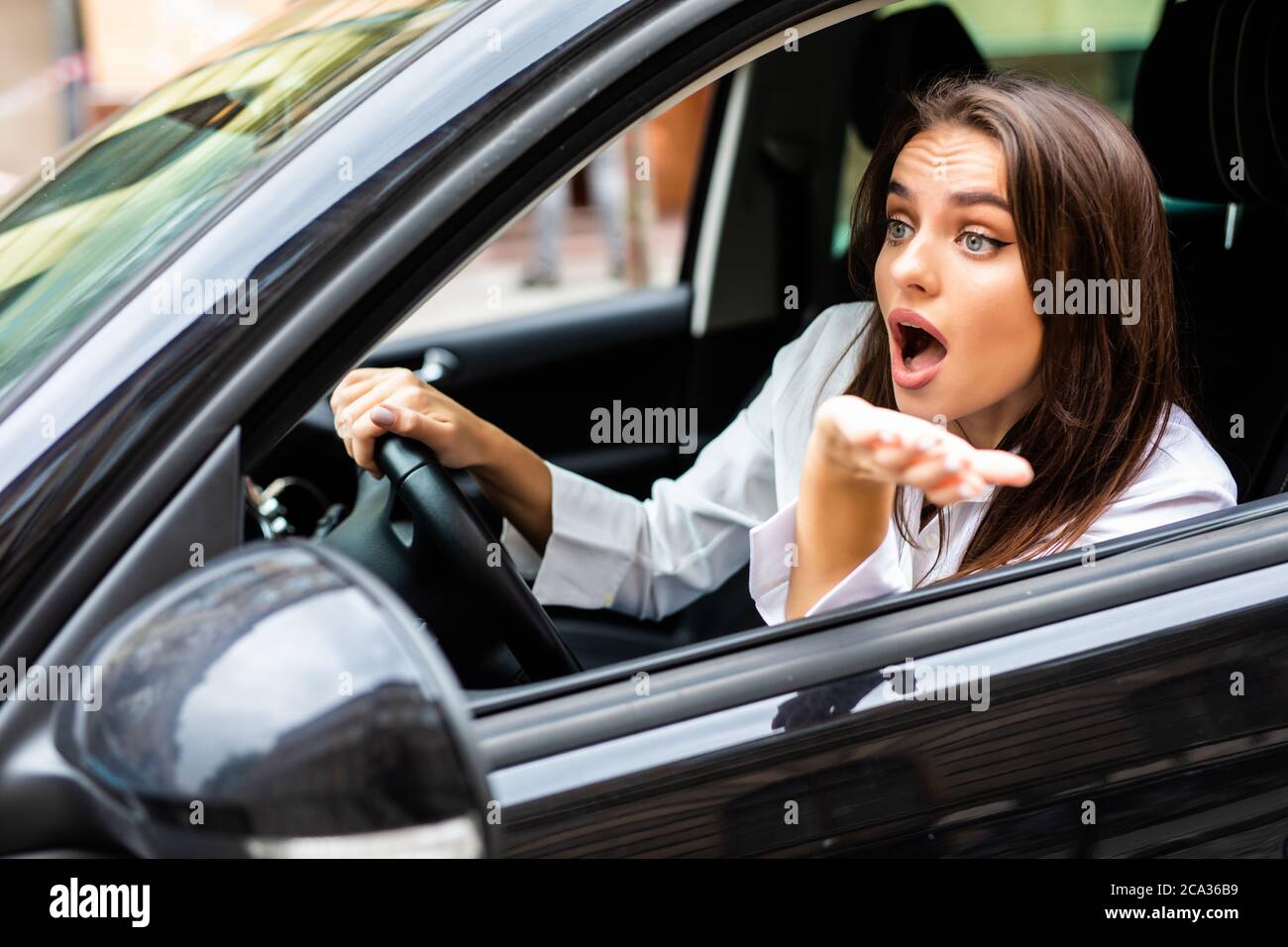 Beautiful angry woman honking in her car while driving Stock Photo - Alamy