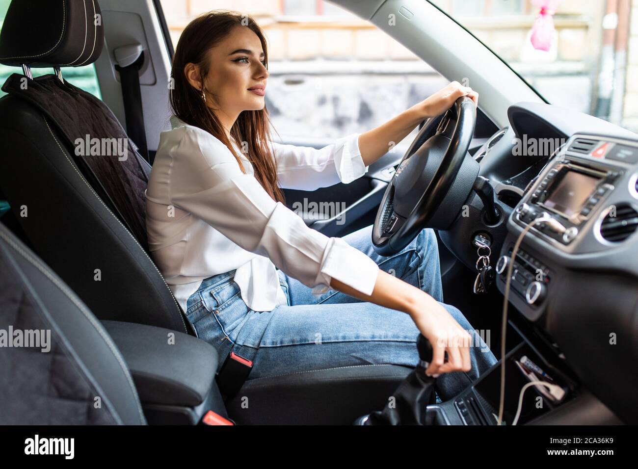 Side View Of A Young Happy Woman Driving Car Stock Photo - Alamy