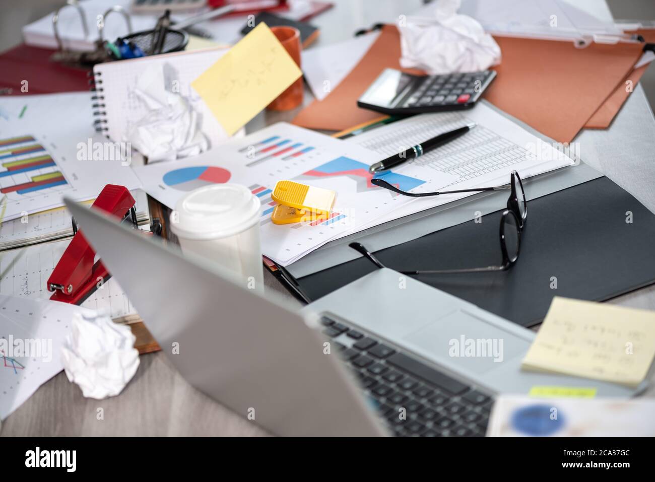 Messy and cluttered office desk Stock Photo - Alamy