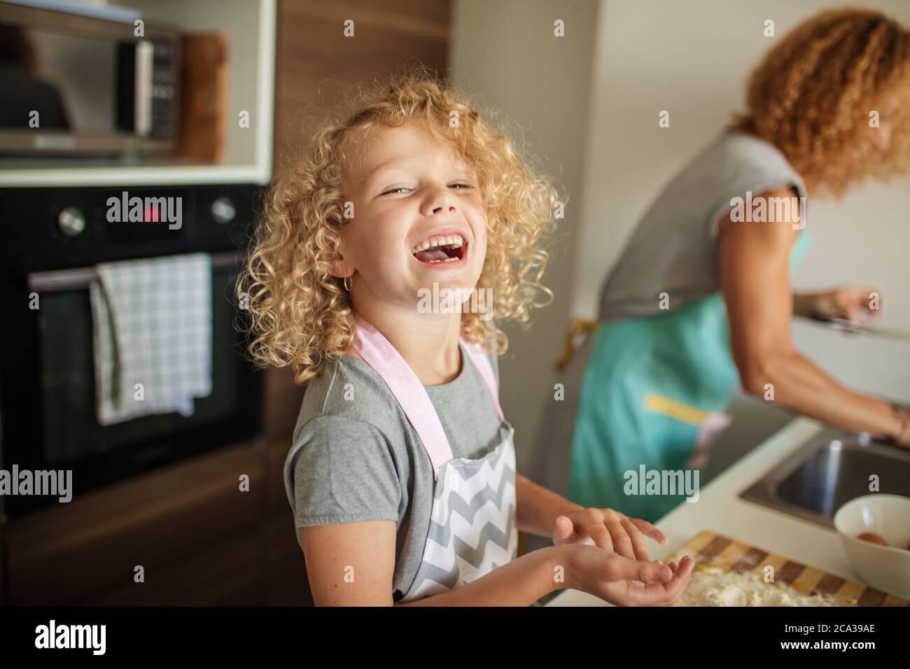 Happy daughter and her loving mother making dinner for Mother s Day ...