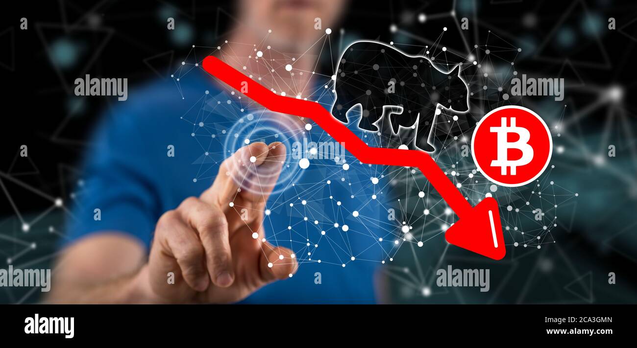 Man touching a bitcoin bearish trend concept on a touch screen with his ...