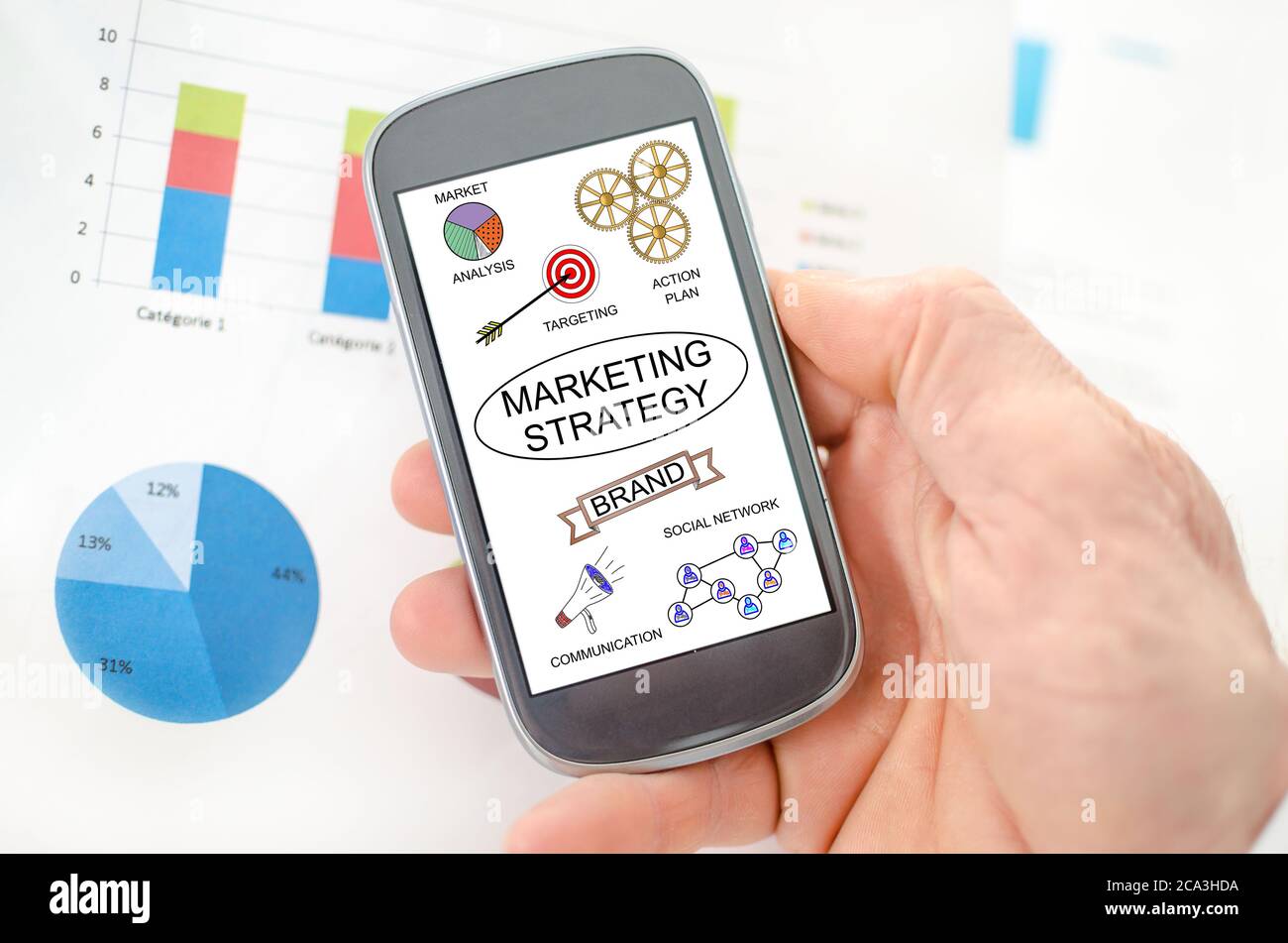 Marketing strategy concept on a smartphone held by a hand Stock Photo ...