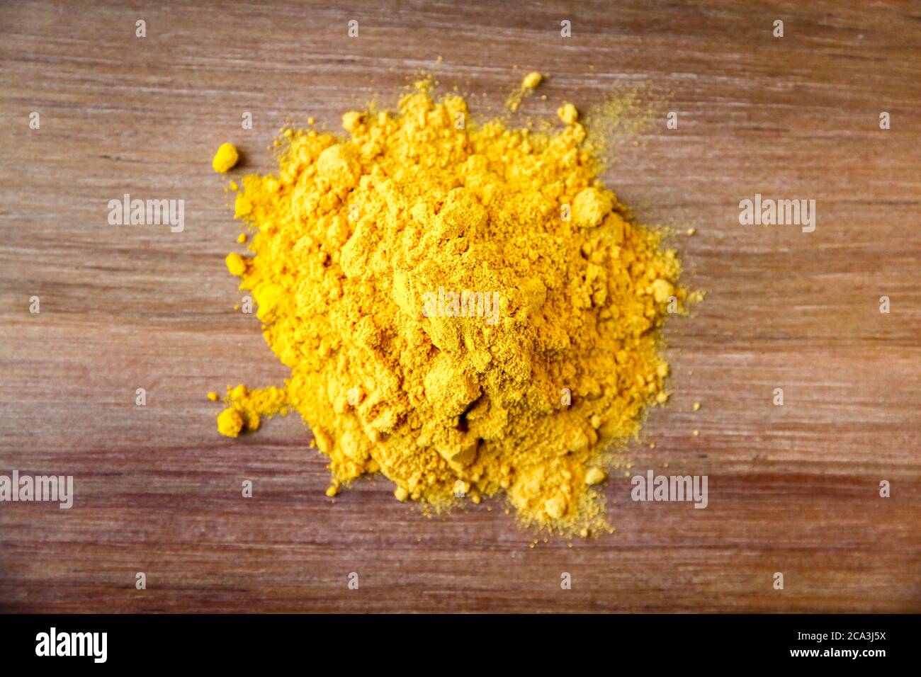 Turmeric spice powder on a wooden cutting board. Top view Stock Photo ...