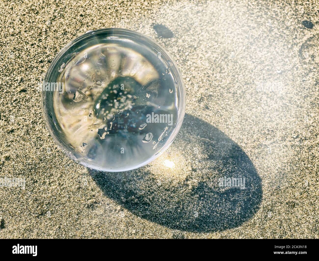 Transparent ball on the beach with sand reflections Stock Photo - Alamy