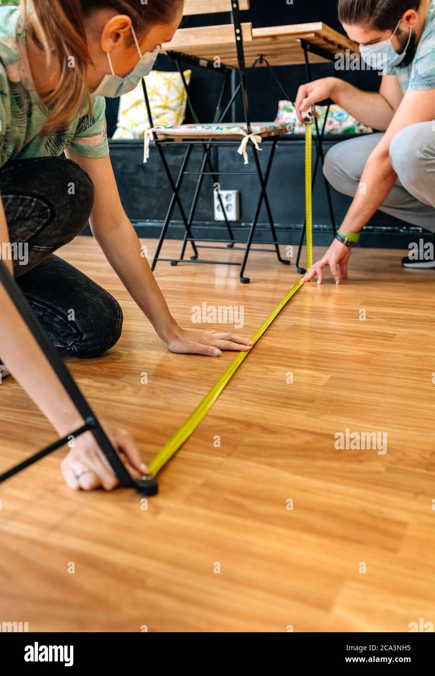 Workers measuring social distance on the floor Stock Photo - Alamy