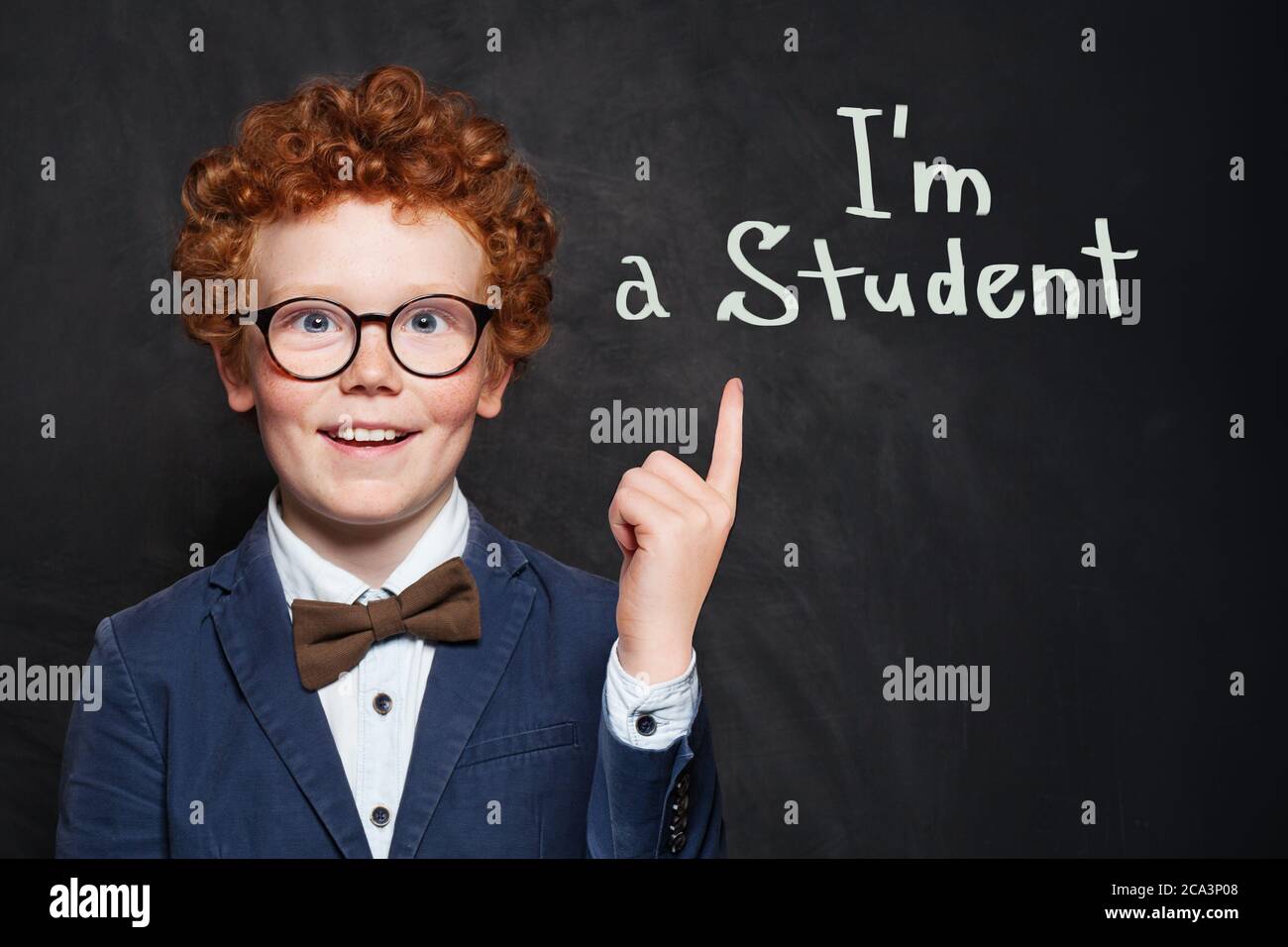 Happy prodigy child student on blackboard background portrait Stock ...