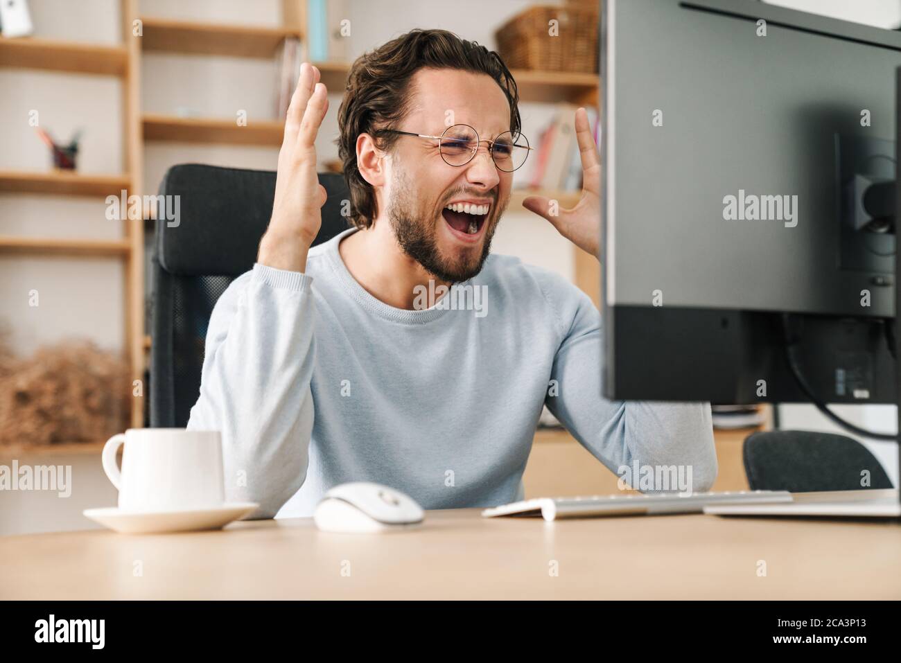 Image of furious bearded programmer man wearing eyeglasses screaming ...