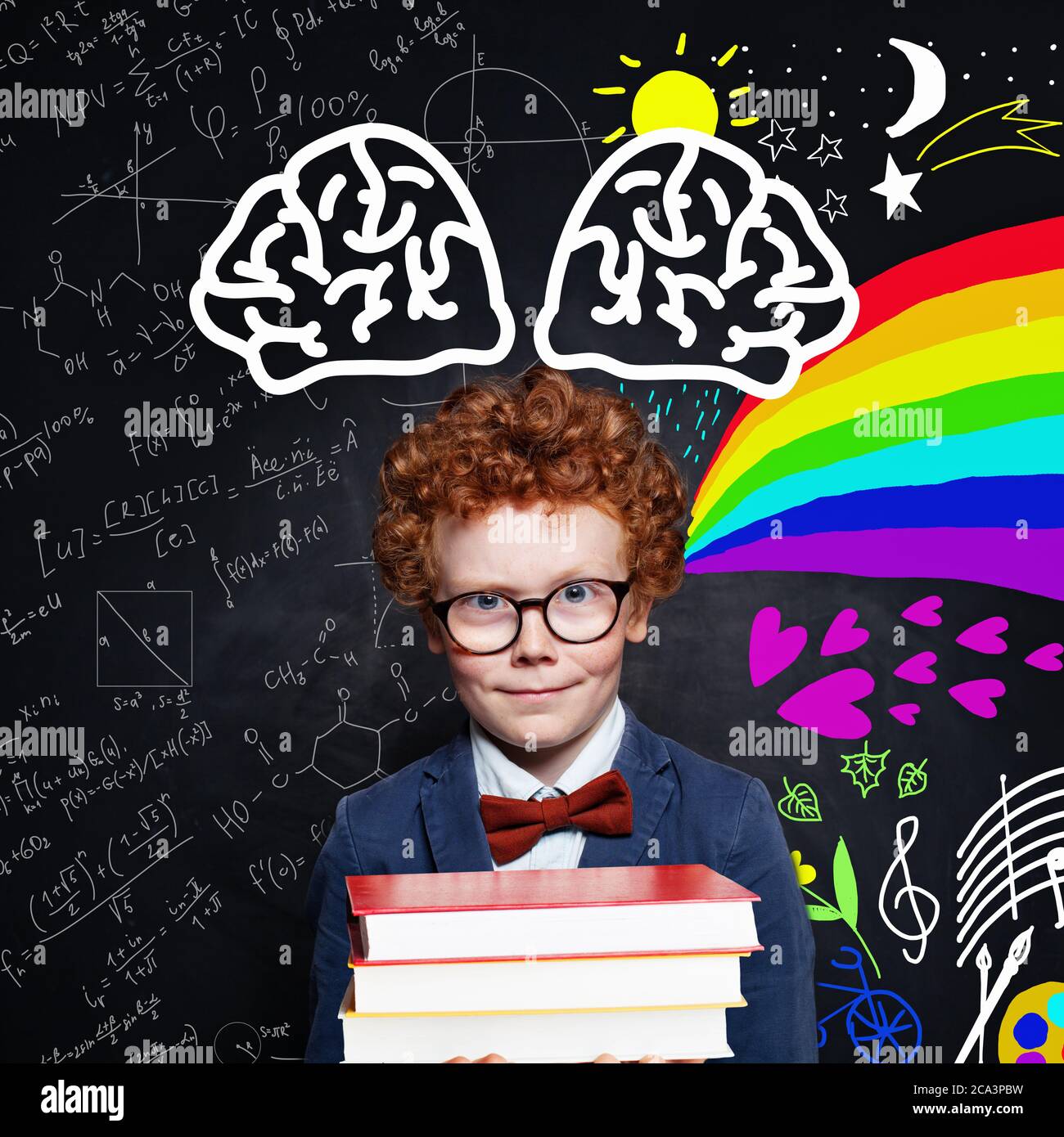 Happy smart child in glasses holding stack of books Stock Photo - Alamy
