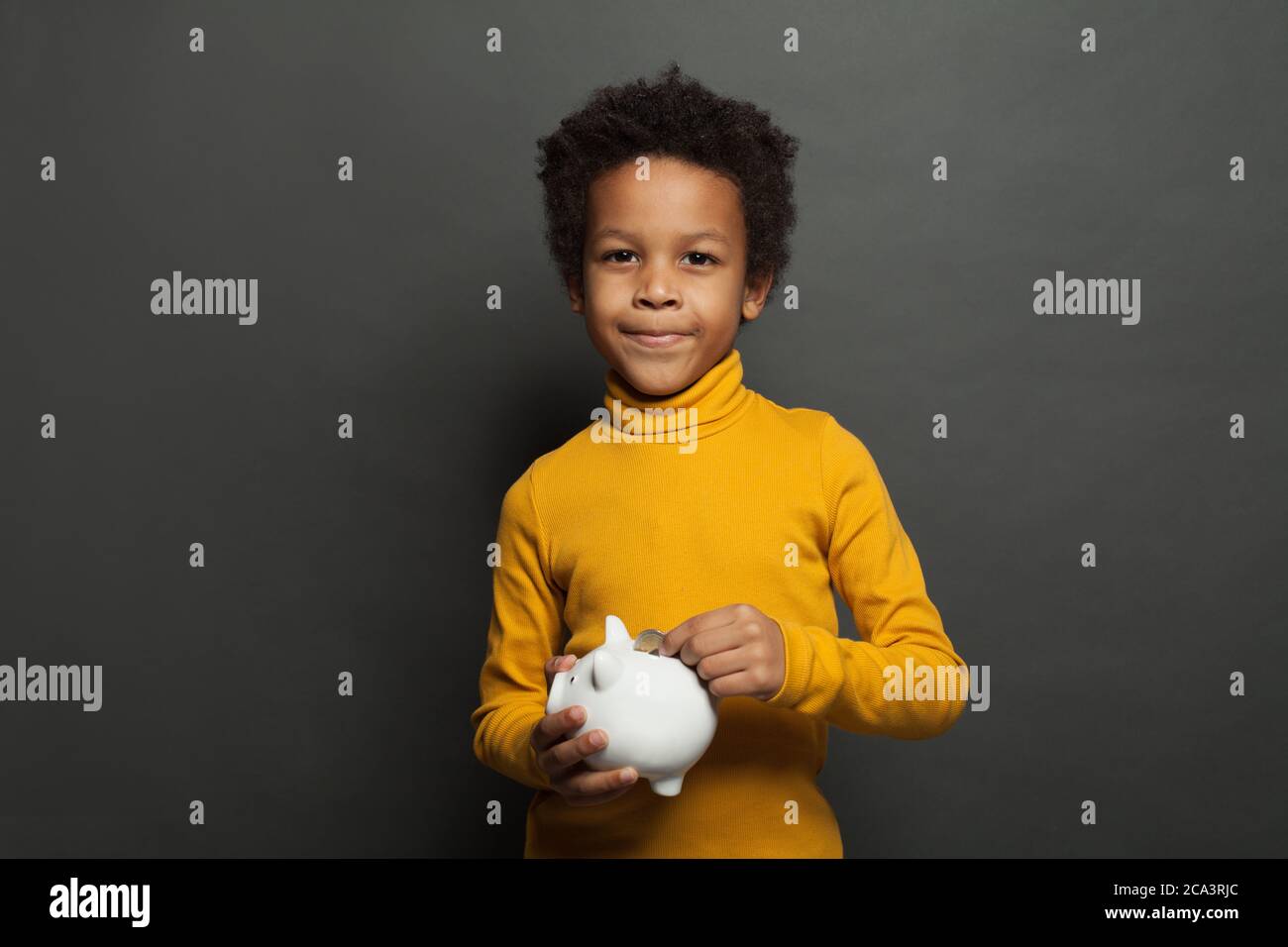 Smart black child with money box and coin Stock Photo - Alamy