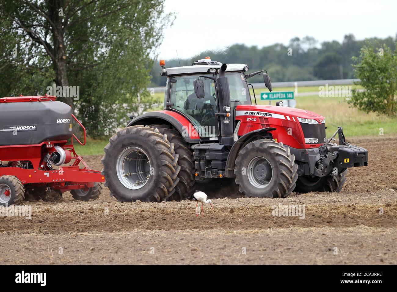 Farmer plowing the field Cultivating tractor in the field Red farm ...