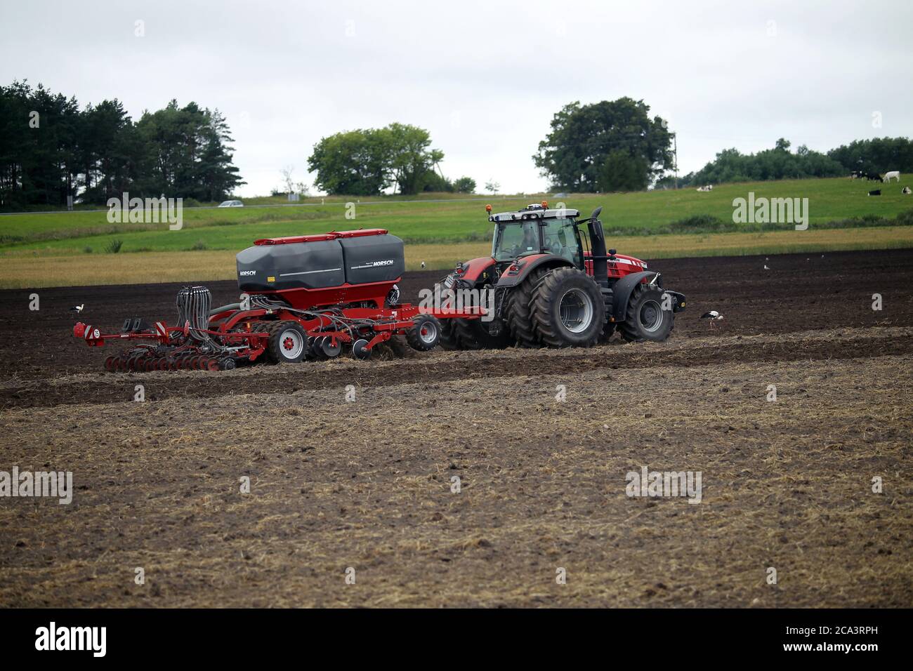Farmer plowing the field Cultivating tractor in the field Red farm ...