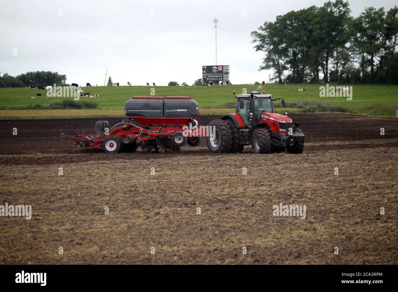 Farmer plowing the field Cultivating tractor in the field Red farm ...