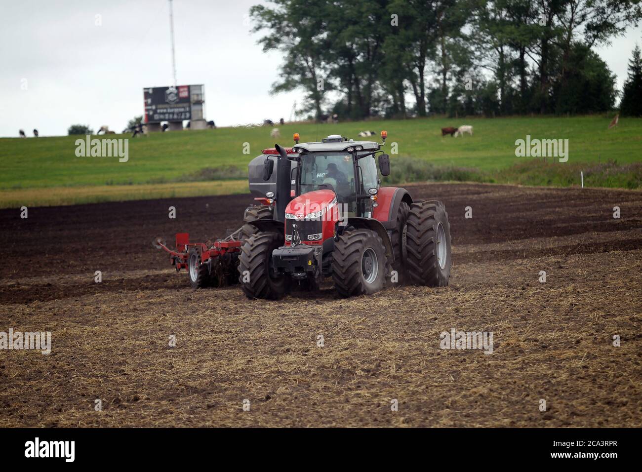 Farmer plowing the field Cultivating tractor in the field Red farm ...