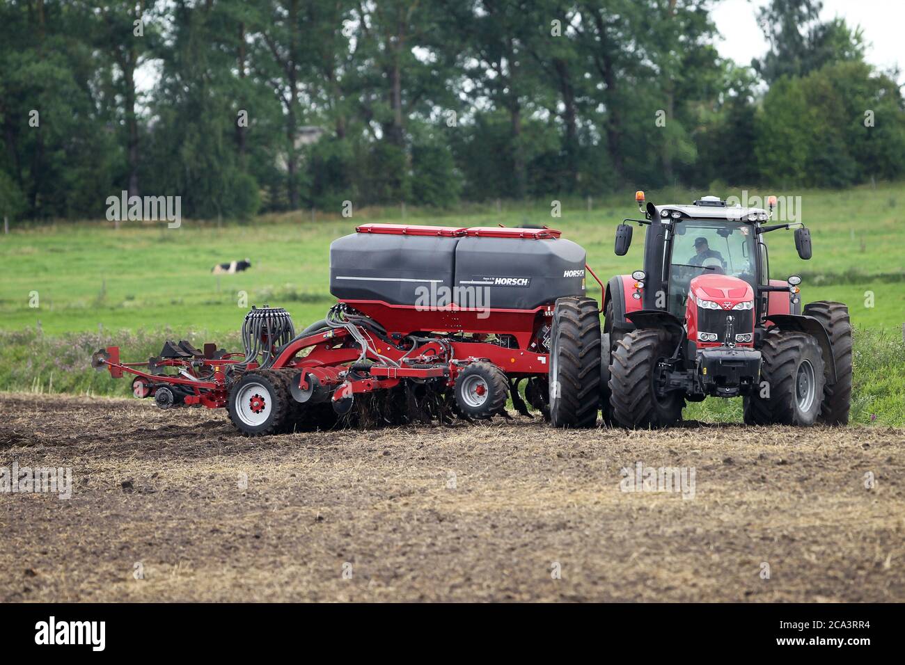 Farmer plowing the field Cultivating tractor in the field Red farm ...