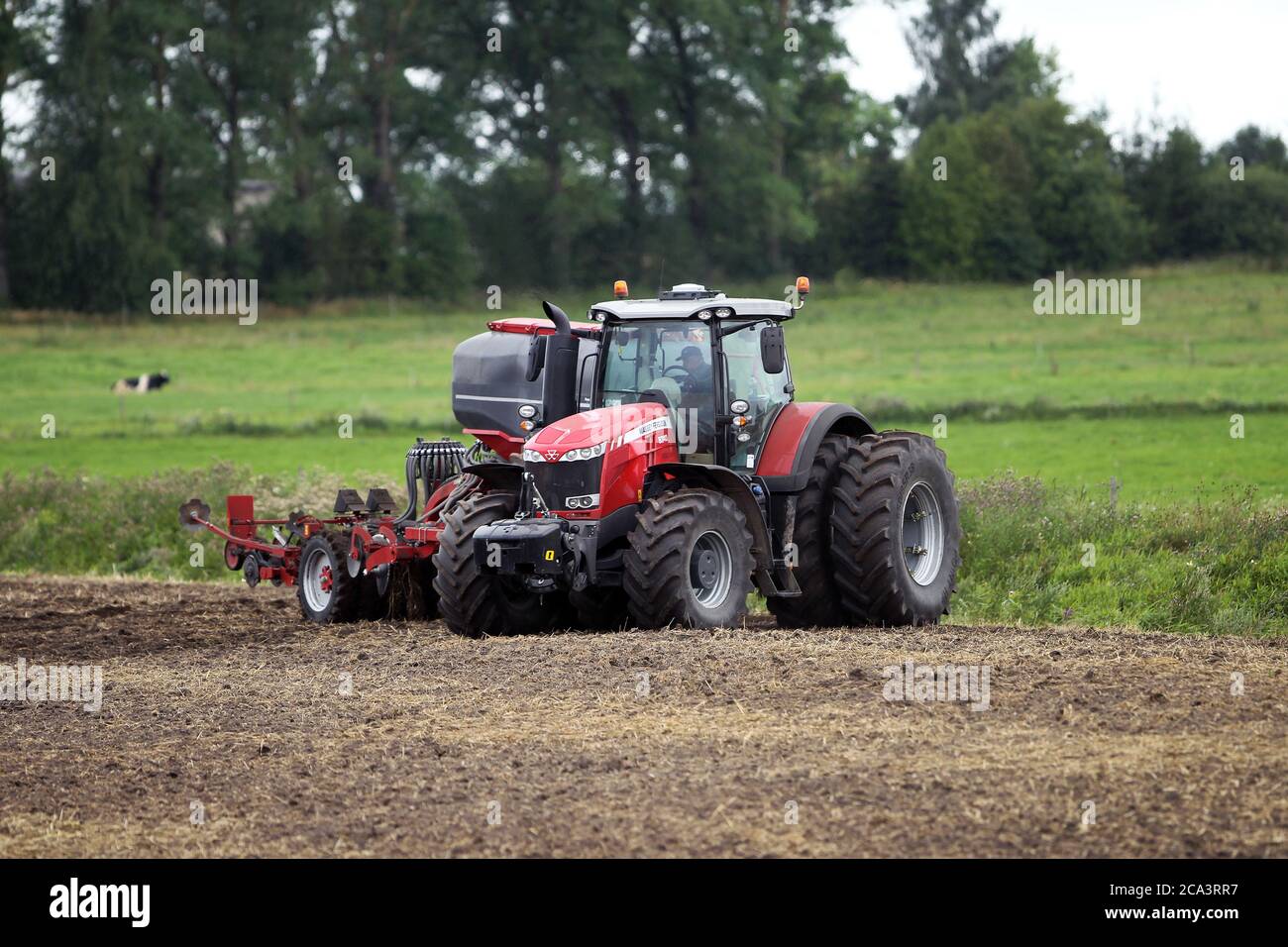 Farmer plowing the field Cultivating tractor in the field Red farm ...