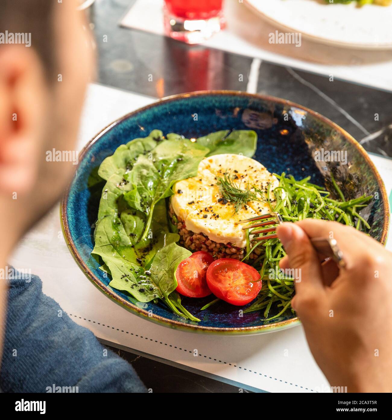 Man eating tasty salad top view Stock Photo - Alamy
