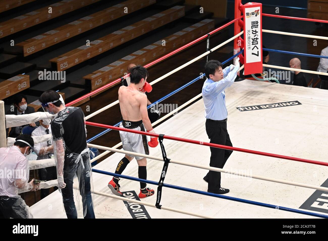 Referee Katsuhiko Nakamura ends the Japanese super flyweight title bout ...