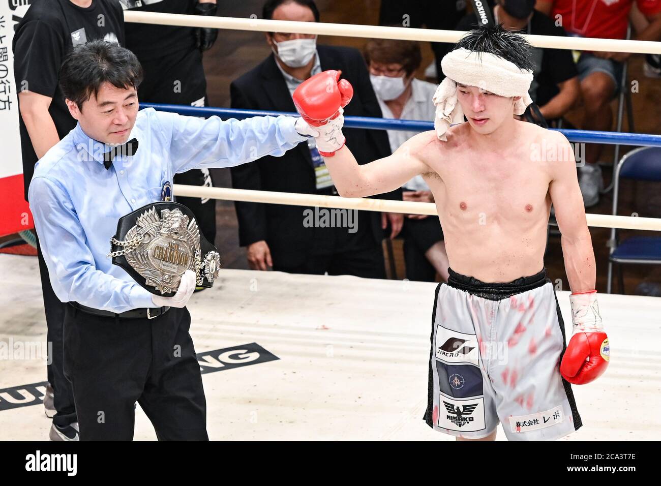 Referee Katsuhiko Nakamura and champiopn Kenta Nakagawa (red gloves ...