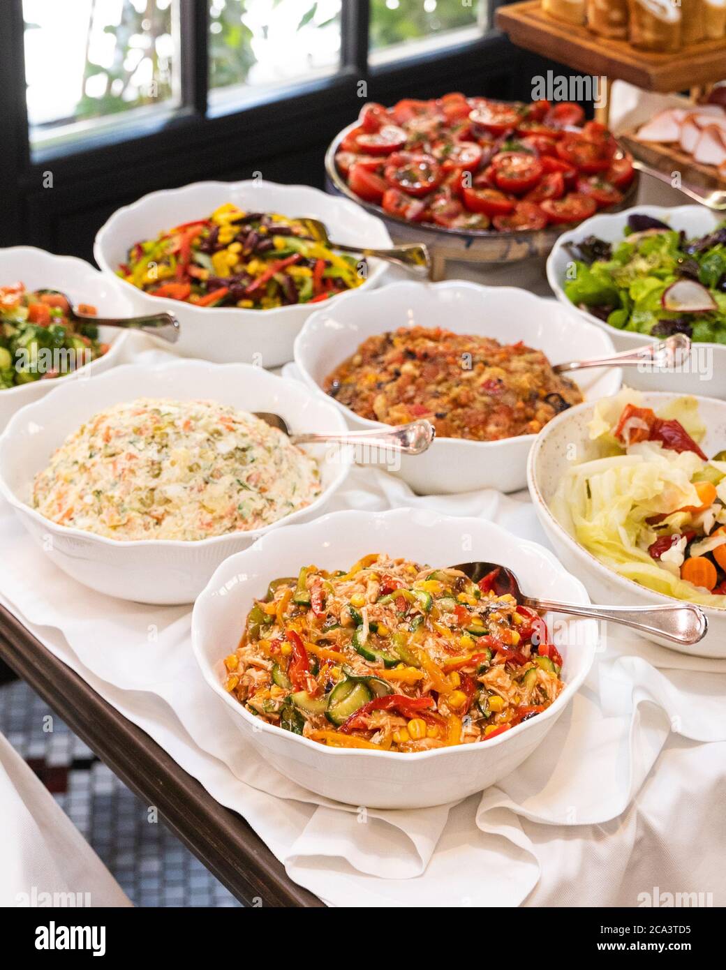Different salads on the white table Stock Photo - Alamy