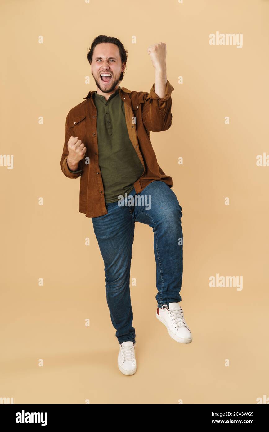 Image of excited man screaming and making winner gesture on camera ...