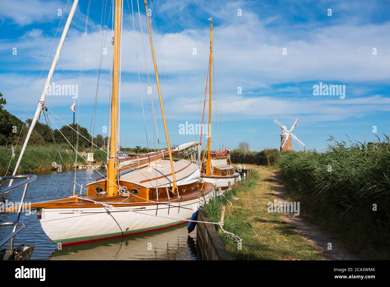 Norfolk Broads, view in summer of boats moored along the tow-path at ...
