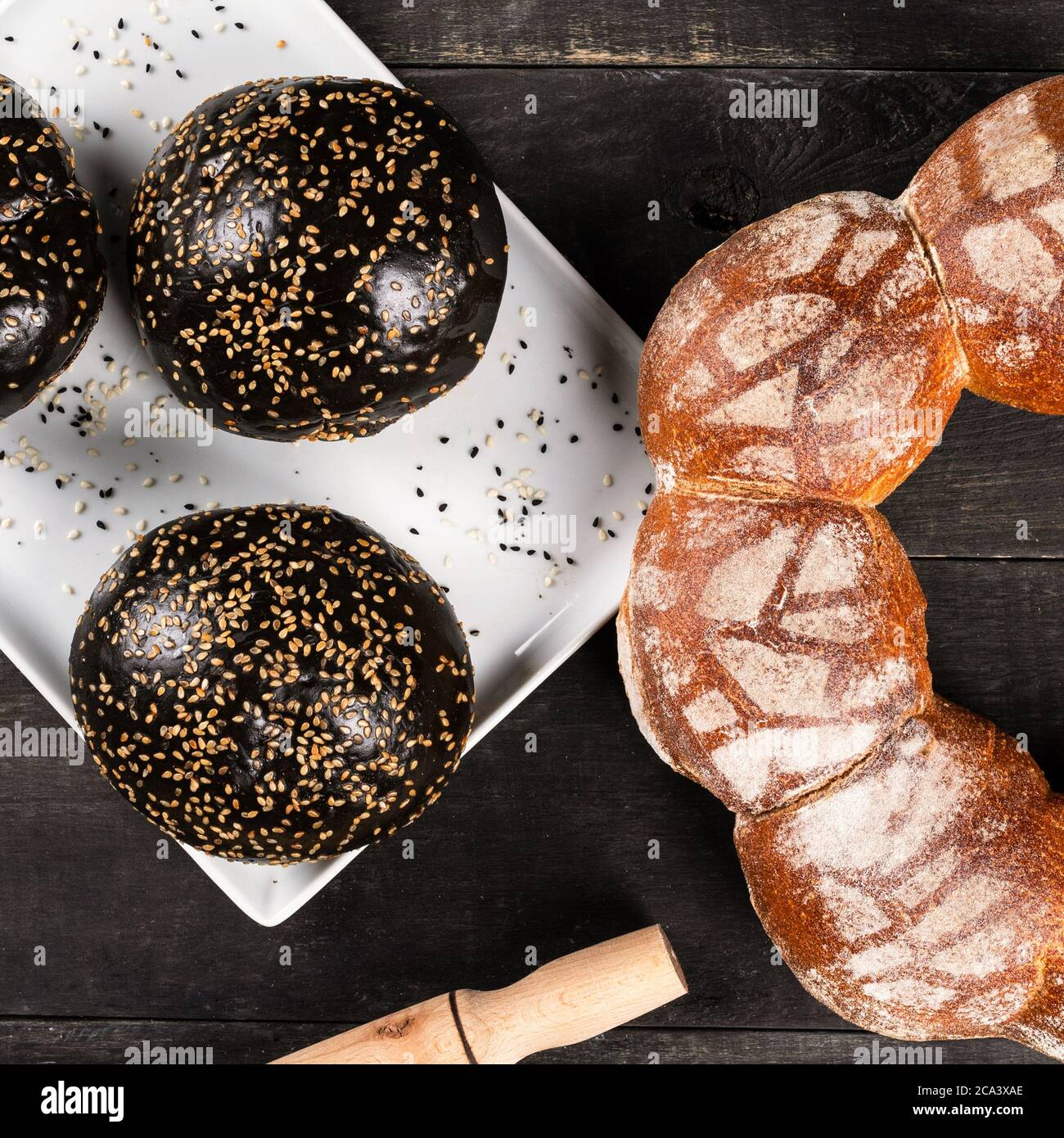 Fresh dark, black and white burger bread, close up Stock Photo - Alamy