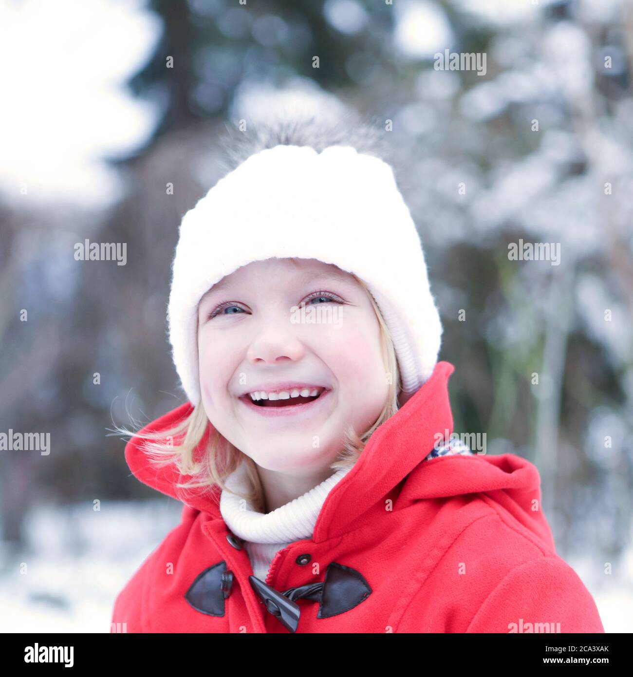 Laughing child outside in winter with snow Stock Photo - Alamy