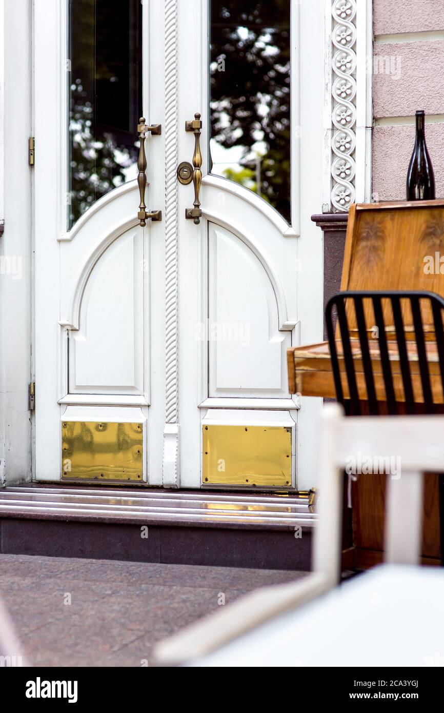 entrance with a stone threshold at the white closed door with a glass ...