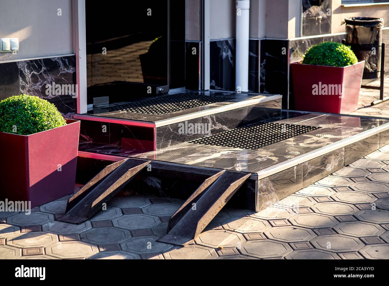 black tile threshold with a step and ramp for chairwheel at the glass ...