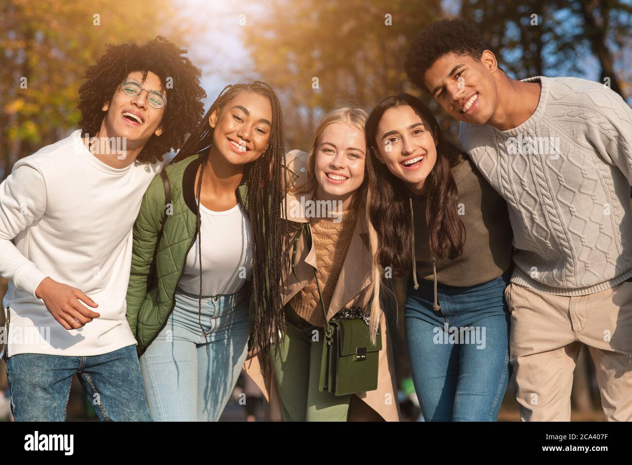 Group portrait of happy multiracial teenaged friends outdoors Stock ...