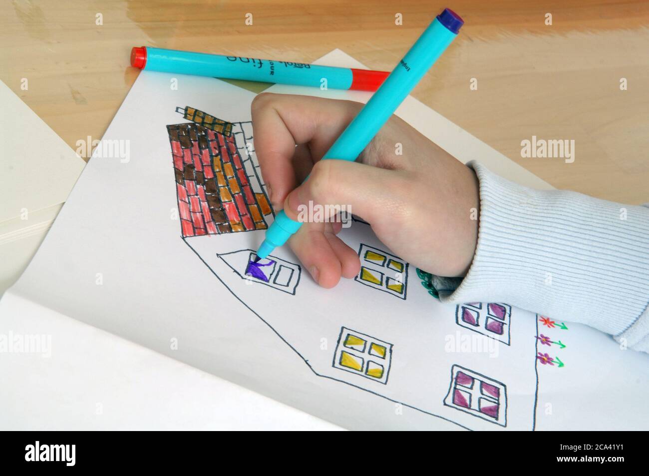 A child's drawing of a house with colourful windows and roof Stock ...