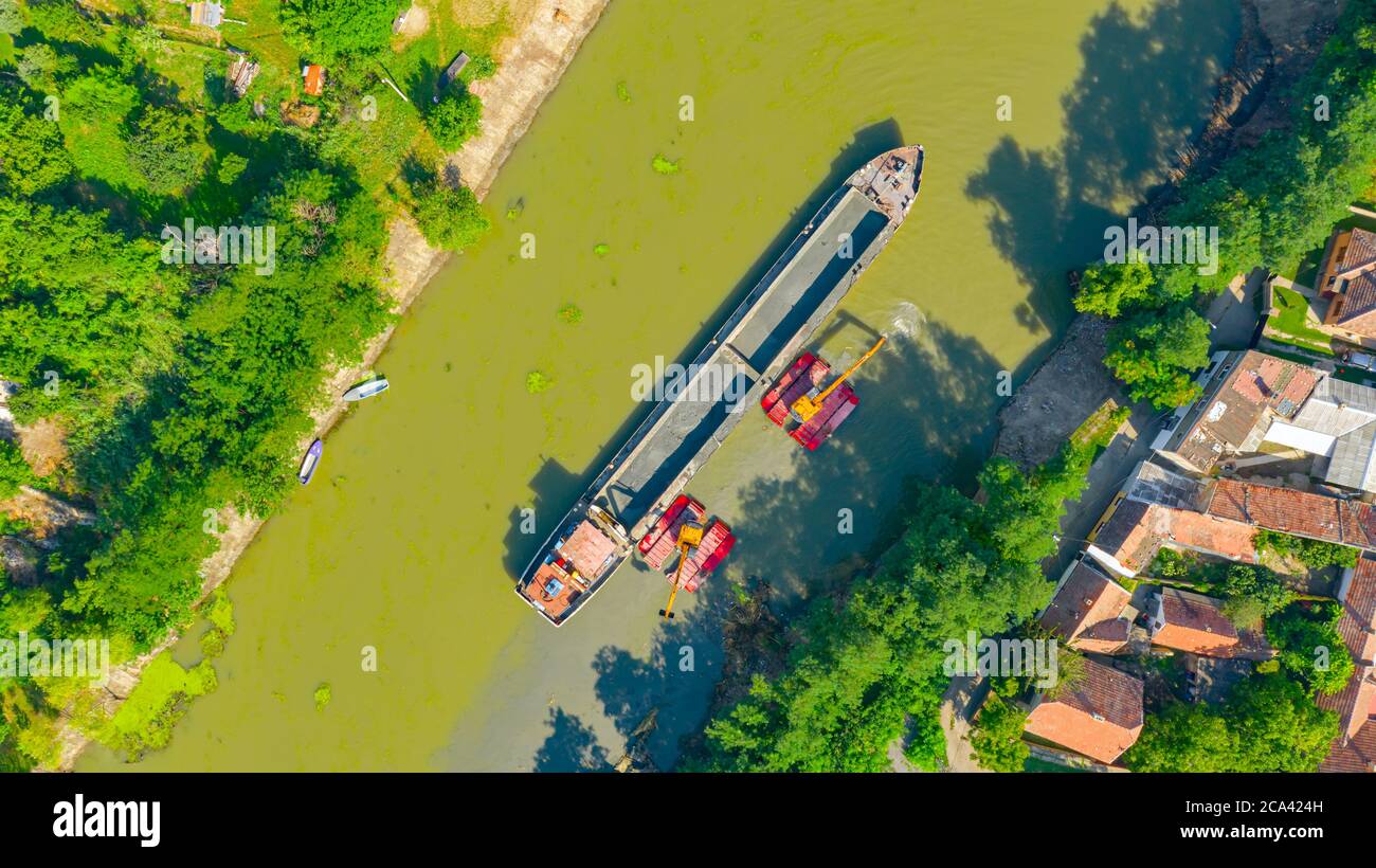 Aerial view on excavator dredge is dredging, working on river, canal ...