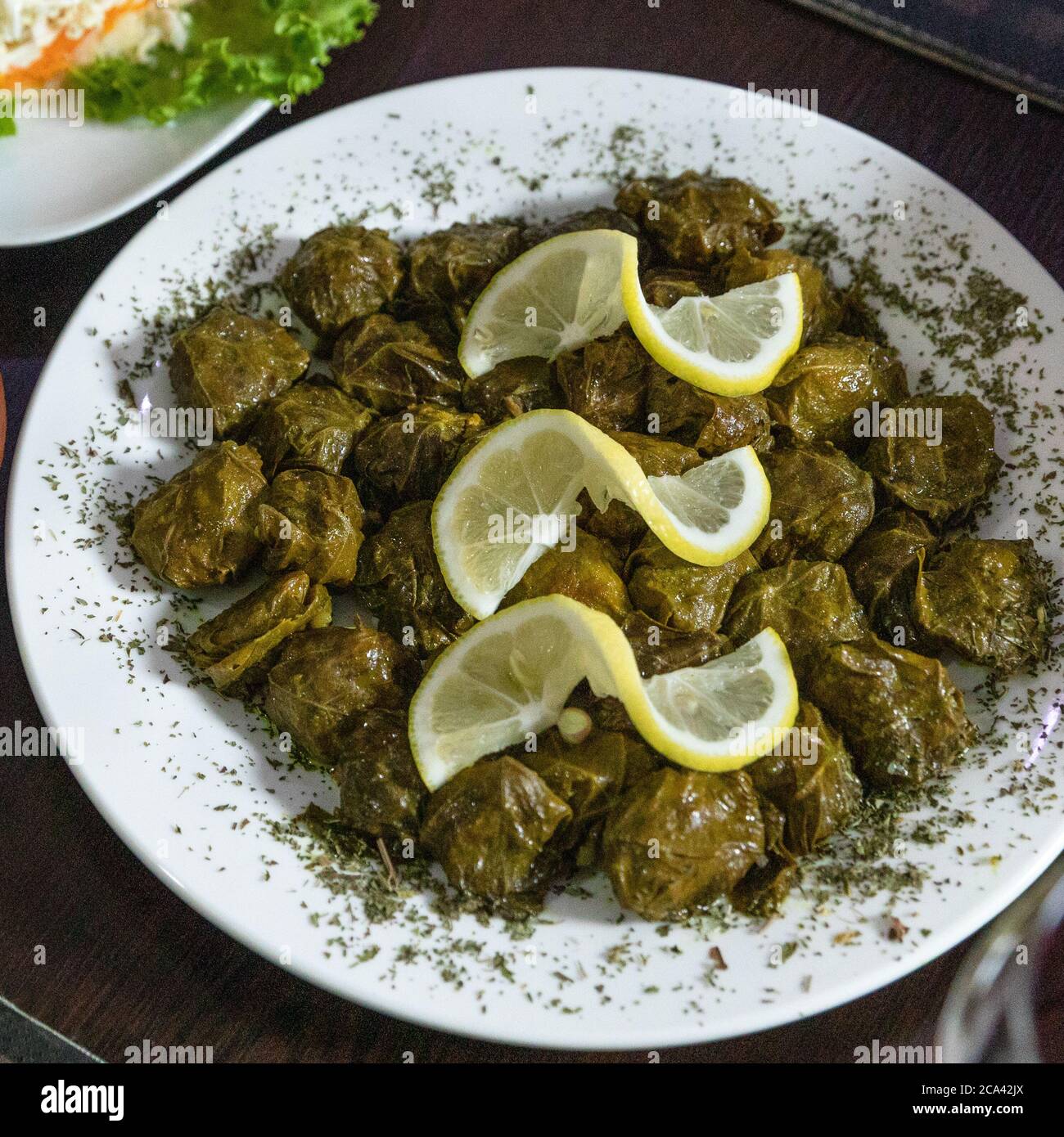 Tasty dolma, meat meal lemon on it, top view Stock Photo - Alamy