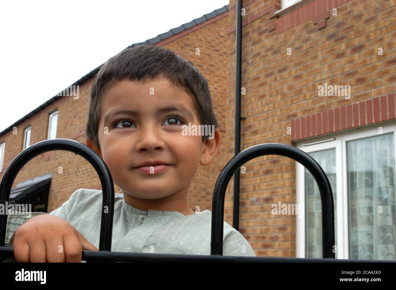 Small boy playing outside his Housing Association home; Halifax ...